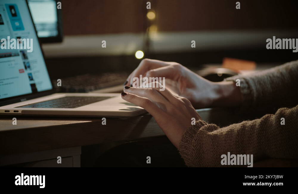 Girl hands on a laptop touchpad. Close-up. Woman in sweater surfing the ...