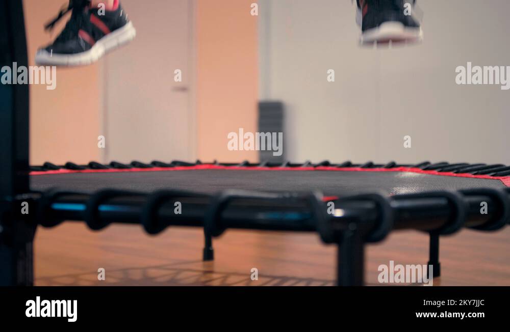CloseUp to Feet Jumping on Mini Trampoline during Fitness Class in the ...