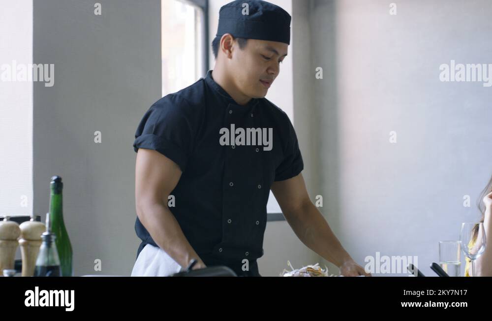 Japanese chef cooking teppanyaki food cuisine in Hibachi steak house ...