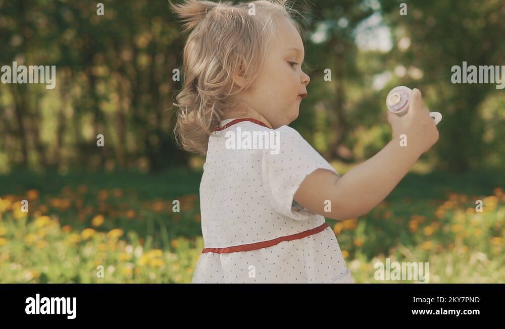 Little Smiling Girl Blowinf Soap Bubbles. Happy Childhood concept Stock ...