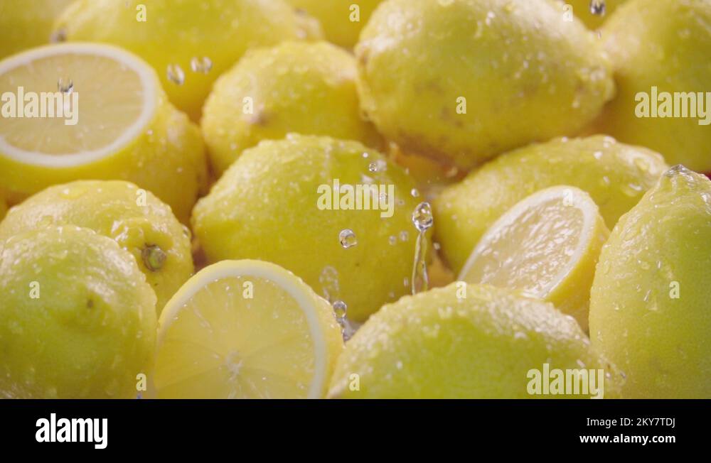 Lemon falling in water with splash between lemons. Slow motion 240 fps ...