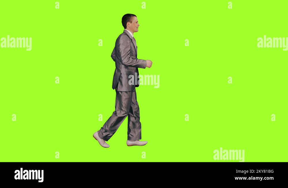 Businessman in gray suit running on green screen background, Chroma key ...