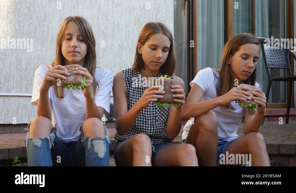 Triple Sisters Twins Teen Girls Sitting On Backyard Porch Terrace Eat