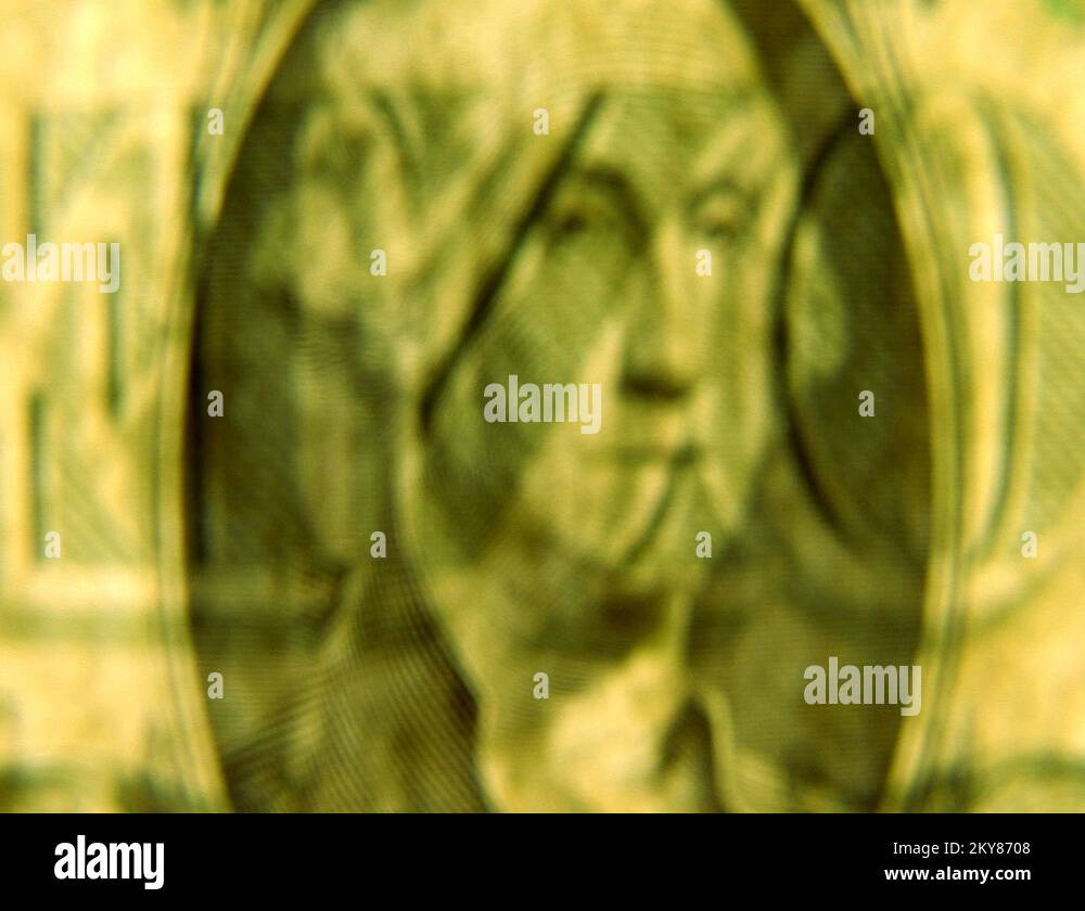 One Dollar bill coming into focus, backlit to show both sides of bill ...
