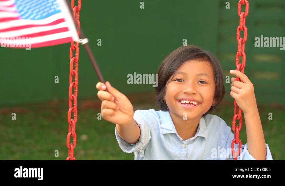 Girl waving American flag while smiling Stock Video Footage - Alamy