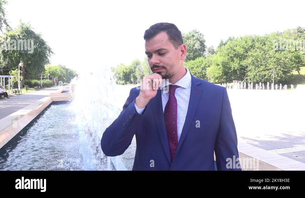 Rubbing his chin beard young salesman banker thinking outdoors standing ...