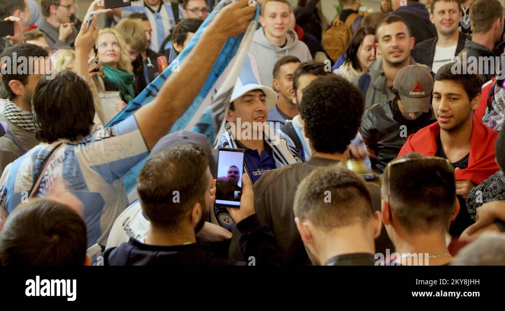 Multicultural happy football fans from different countries singing song ...