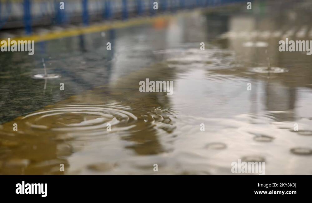 drops of rain fall on platform, railway concept, weather concept, urban ...