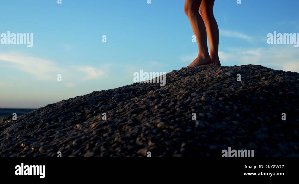 Female volleyball player standing on a rock in the beach 4k Stock Video ...