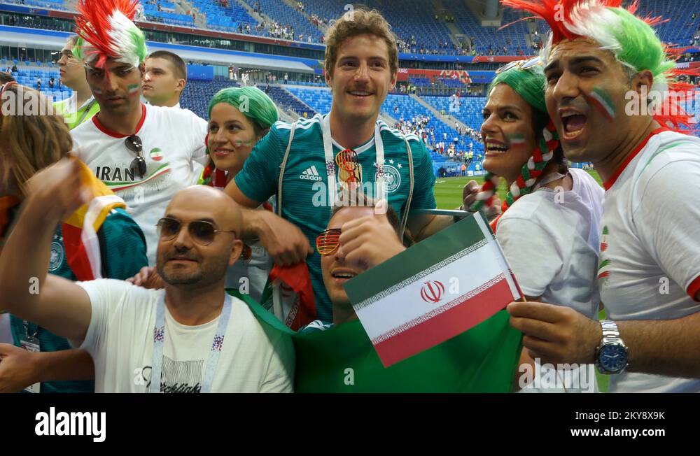 Iranian crowd of football fans in stadium talking to german fans in ...