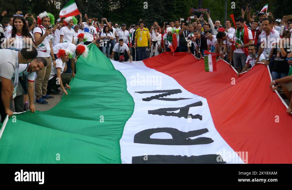 Iranian crowd of fans in street waving pulling up and down a big giant ...