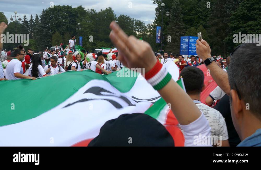 Iranian crowd of fans in street waving a big giant flag dancing ...
