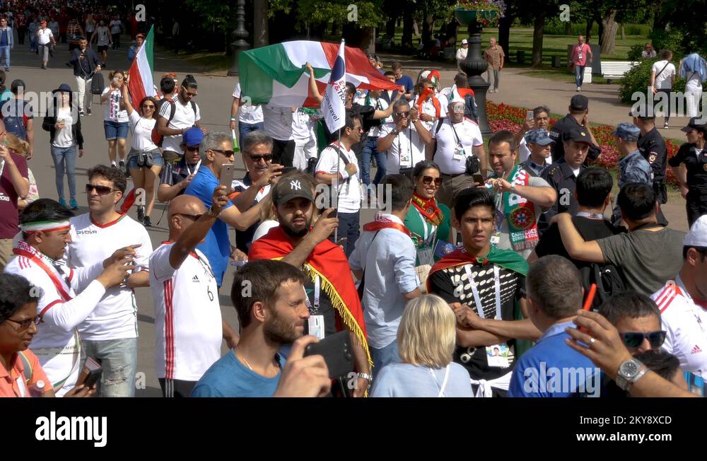 Iranian crowd of football fans in street waving big flags chanting and ...