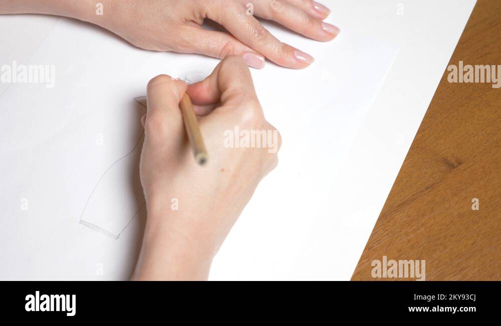 Slow motion . 4k, close-up, top view. a female hand draws with a pencil ...