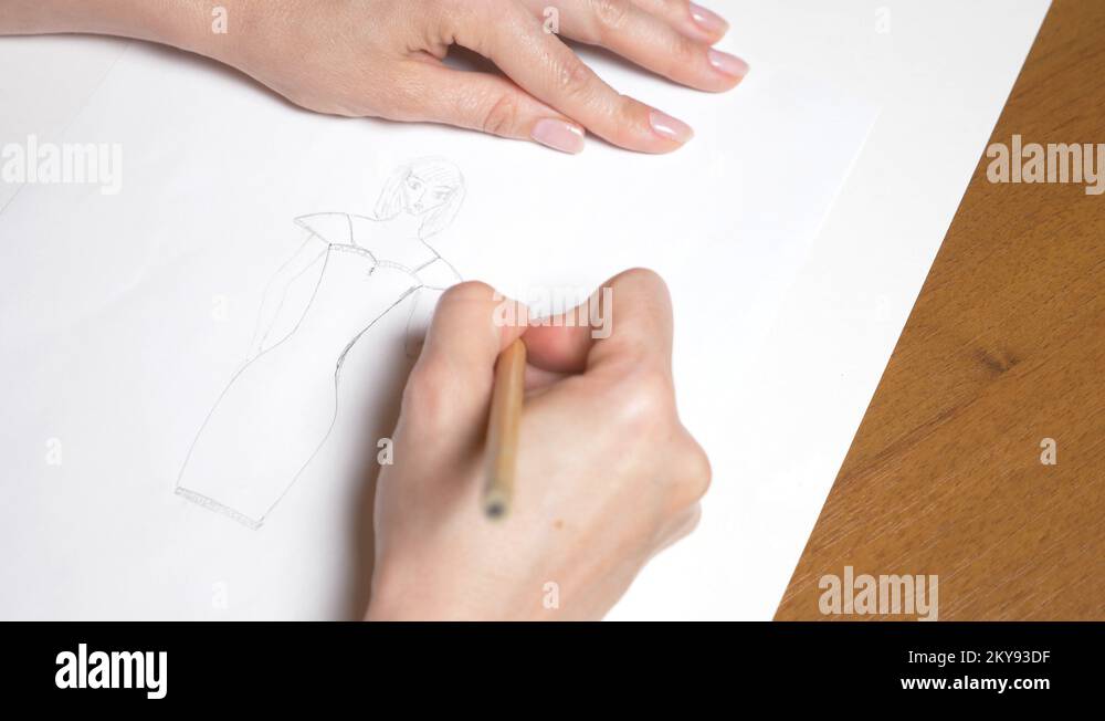 Slow motion . 4k, close-up, top view. a female hand draws with a pencil ...