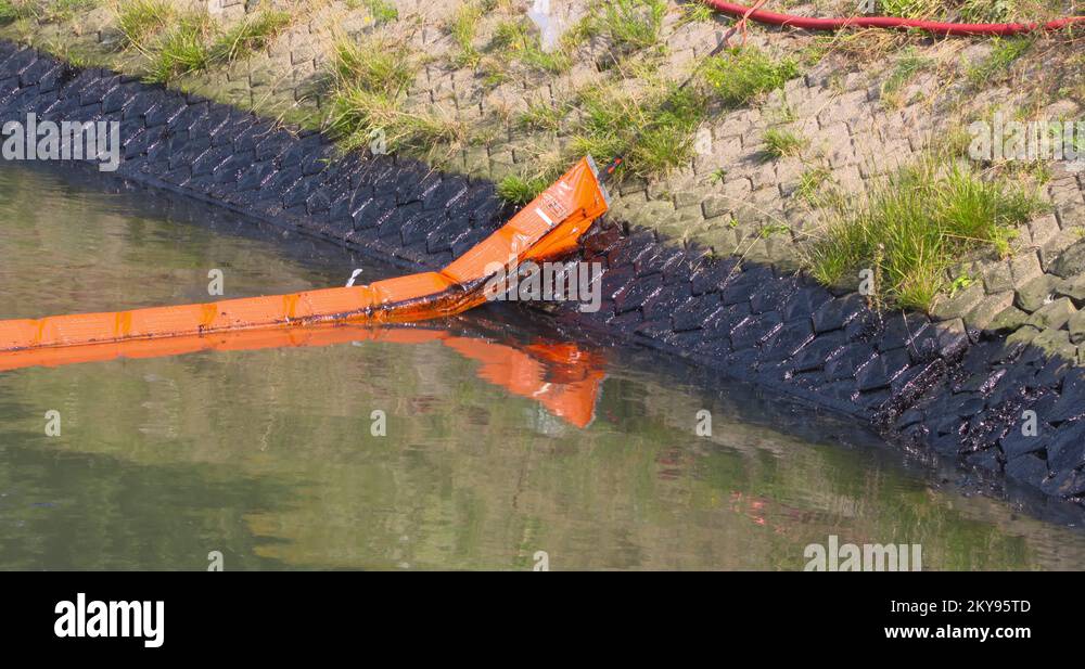 oil spill containment boom floating on water surface at oil ...