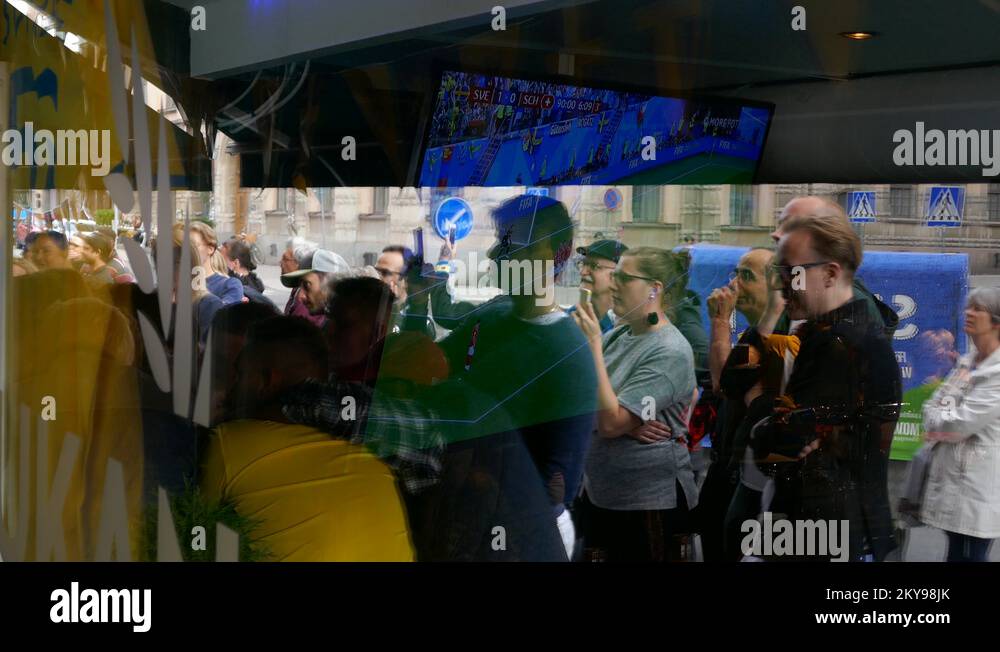 Swedish fans watching their moment of victory in a bar TV, reflection ...