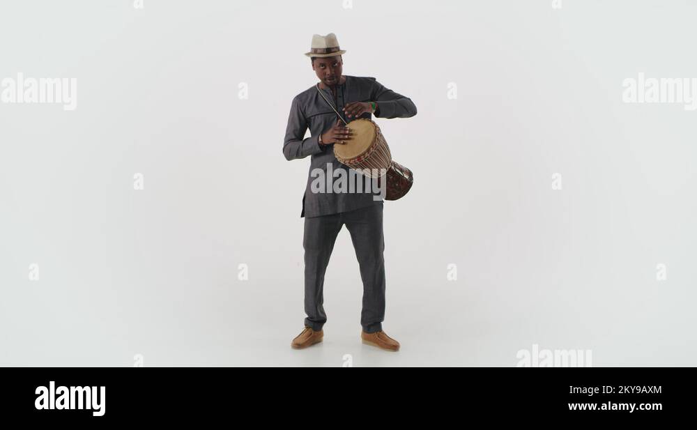 Full-height shot African man dressed in traditional cloth playing on ...