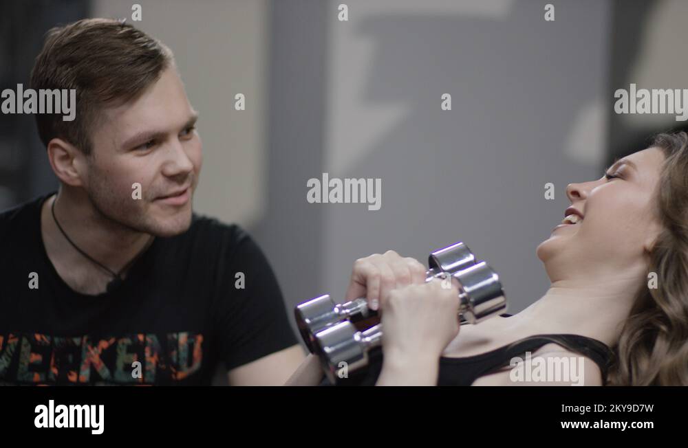 nice blonde girl with curle hair in a black top with blue eyes does a ...