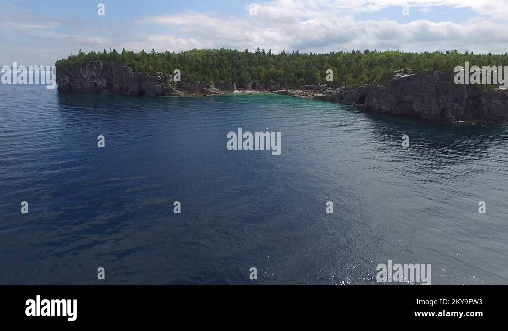 Stunning aerial view of natural rocky pool along shoreline with ...