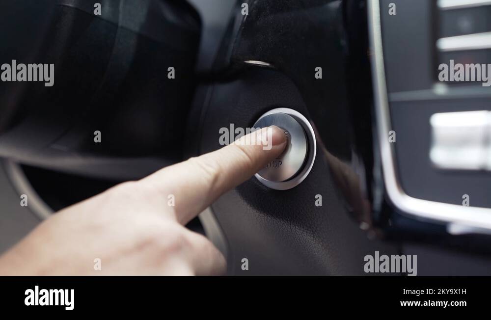 Driver hand pushes engine start stop button. Stock. Modern luxury ...