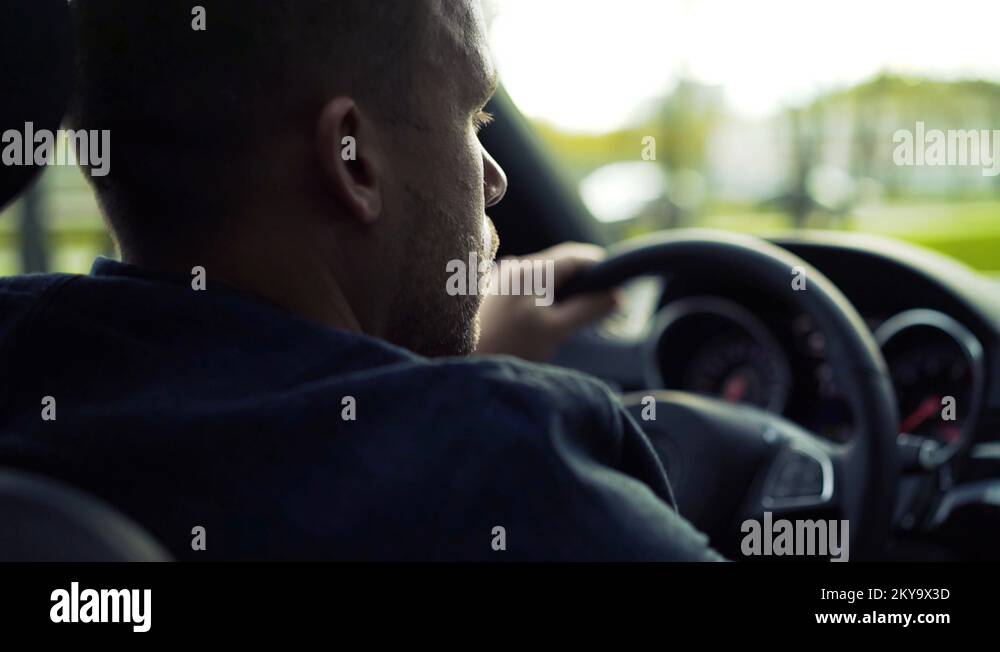 The young man behind the wheel driving car. Stock. Businessman in the ...