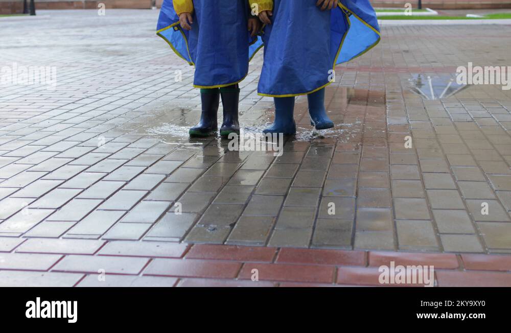 Two children are dancing in the puddle Stock Video Footage - Alamy