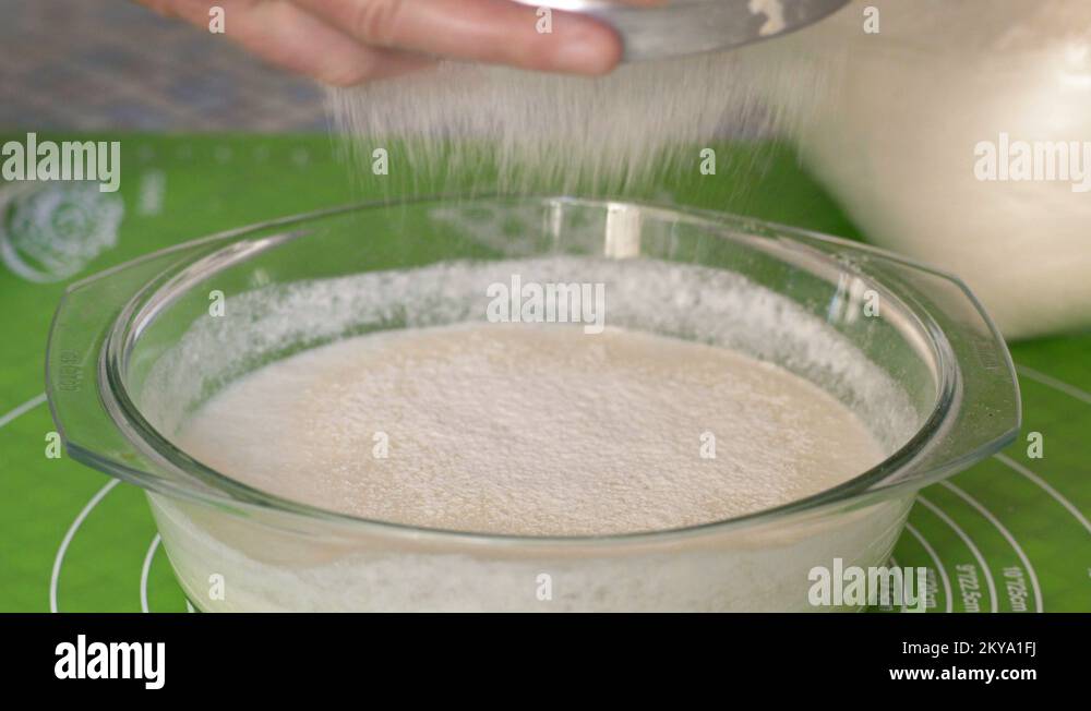 Close-up, Mature Woman Siping Flour Through a Sieve in the Glassware ...