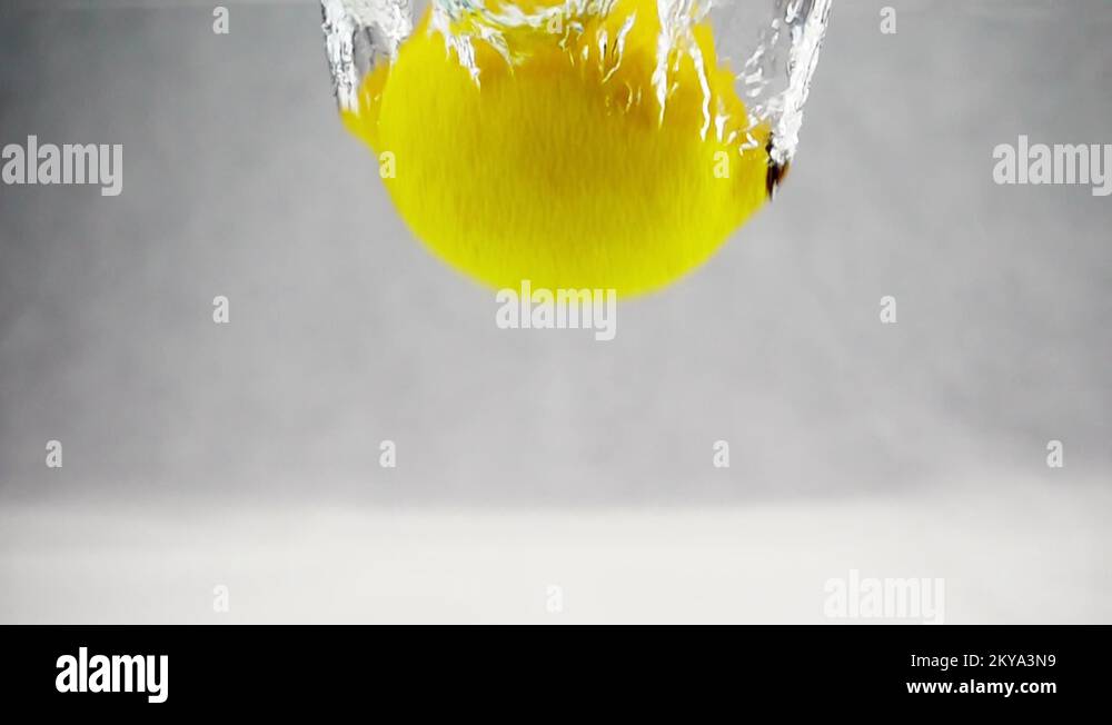 Yellow lemon falling into the water with large bubbles in slow motion. Fruit on Stock Video ...