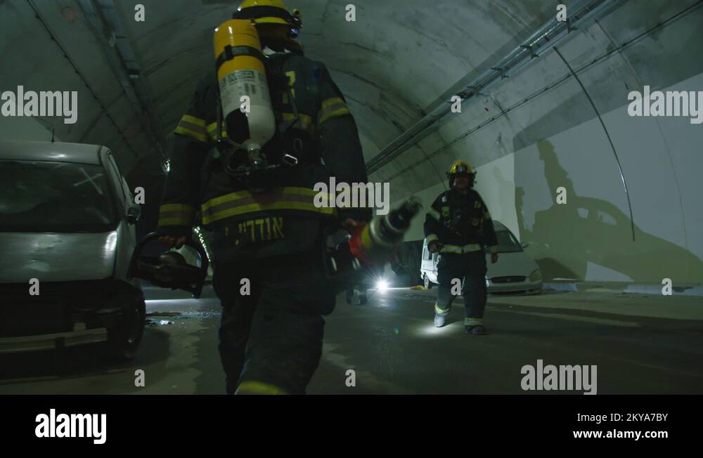 Car accident scene inside a tunnel, firefighters rescuing people from ...