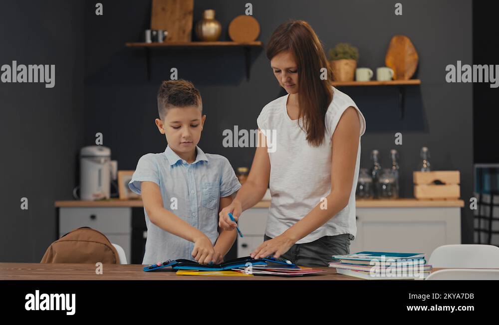 Mom helps her son prepare a backpack for school. Back to school Stock ... Mom helps her son prepare a backpack for school. Back to school Stock ...