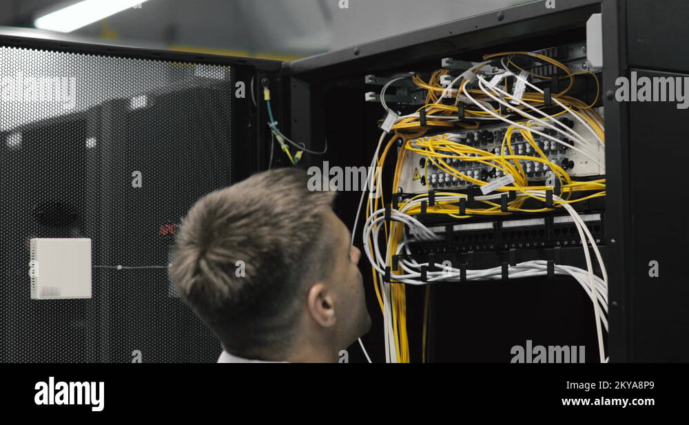 Male Server Engineer Walks Through Working Data Center Full of Rack ...