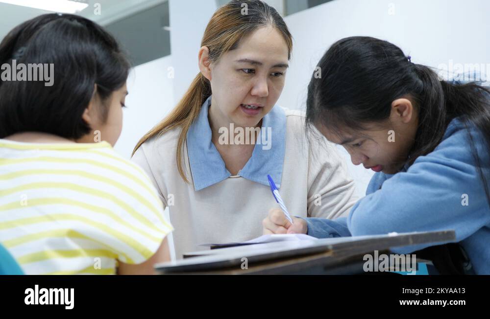 4K Happy Asian student girls studying with teacher in classroom Stock ...