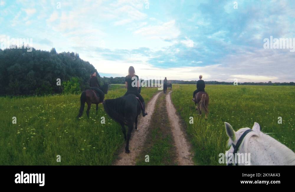 Rider on white horse following to the group of women on horseback Stock ...