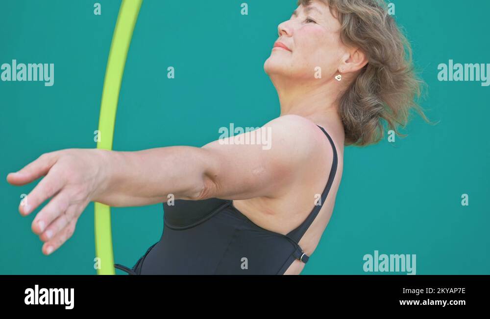 Handsome 60 Years Old Women Are Smiling She Twists A Hoop On Her Hand