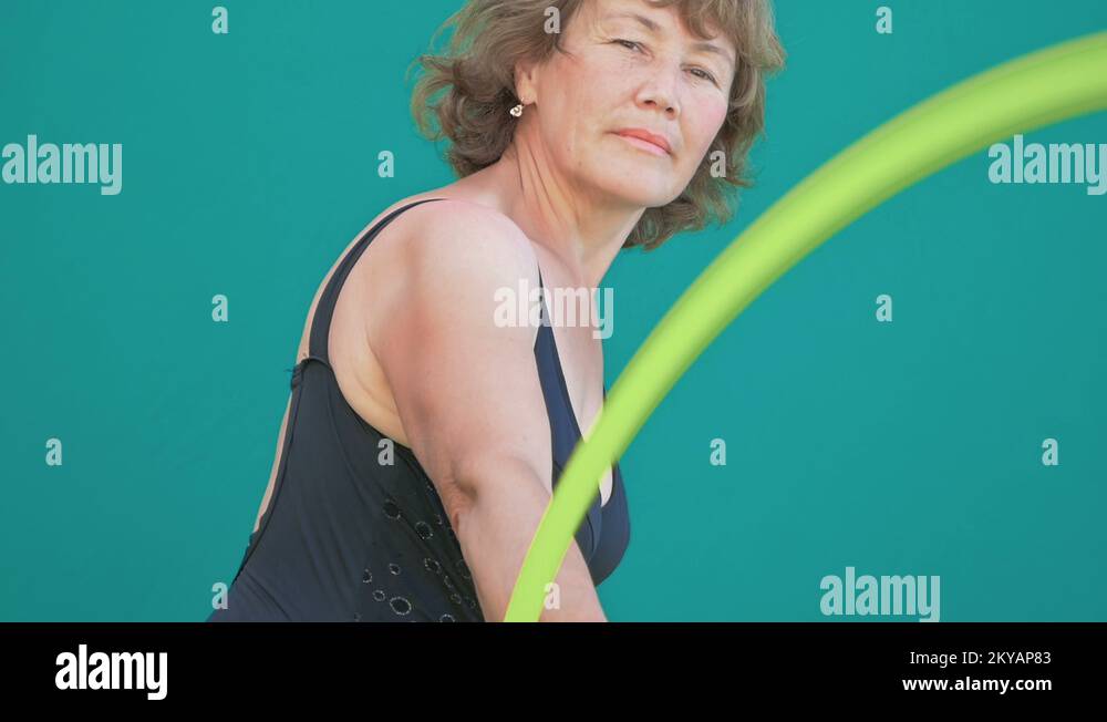 handsome-60-years-old-women-are-smiling-she-twists-a-hoop-on-her-hand