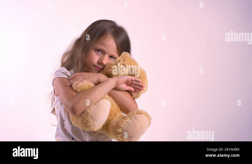 Little cute girl hugging her plush teddy bear, kid embracing toy ...