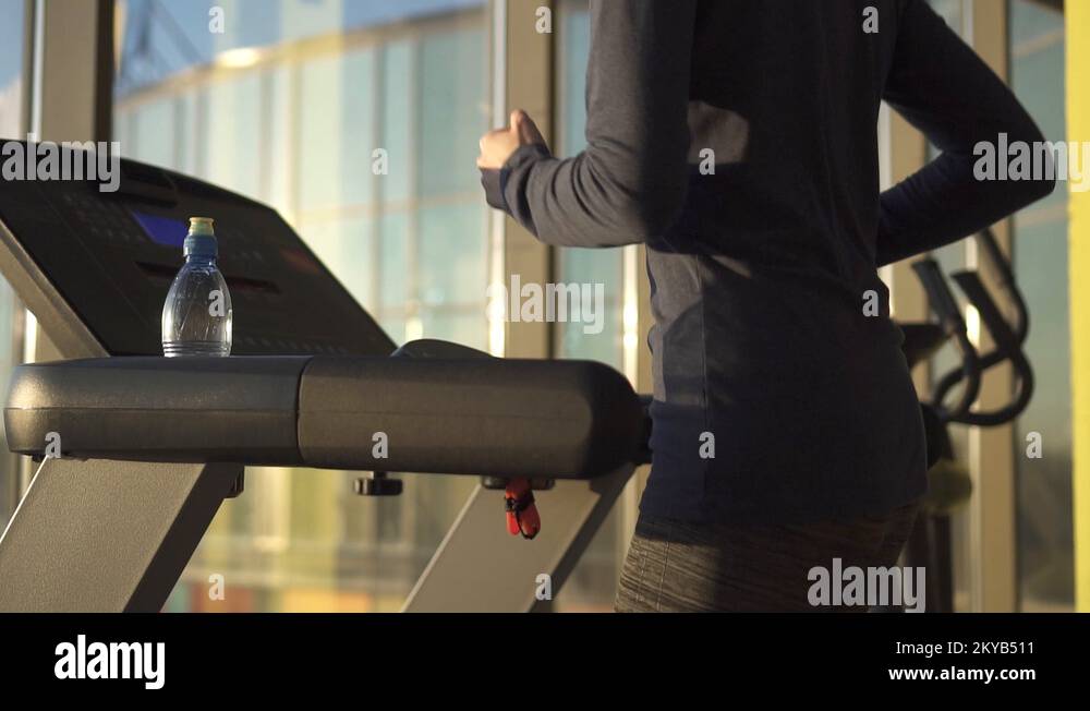 Close up of a young sporty muslim girl in a hijab running on a ...