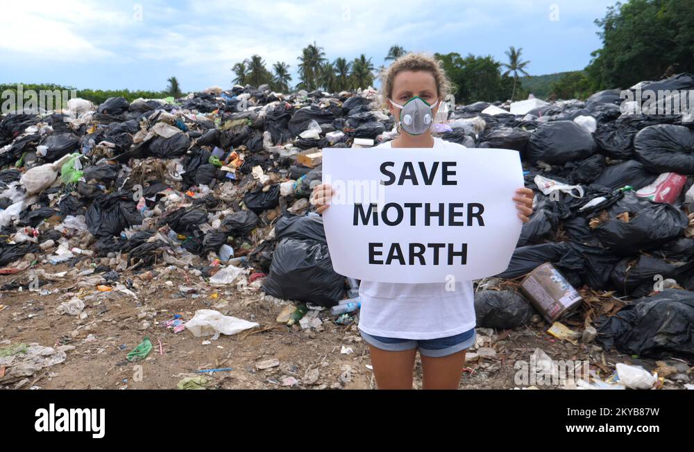 Environmental Activist Standing On Waste Landfill Holding Save Earth ...