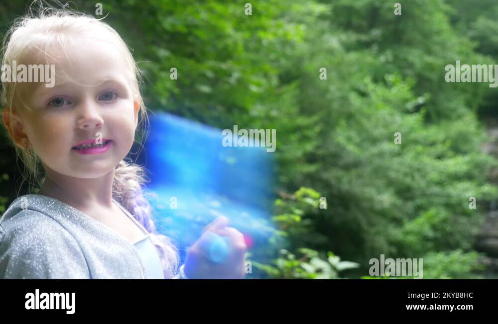 little girl model in a beautiful blue dress posing in a forest. 4k ...