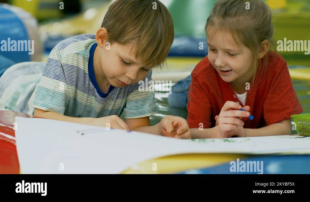 Two Little Friends Drawing with Crayons Stock Video Footage - Alamy