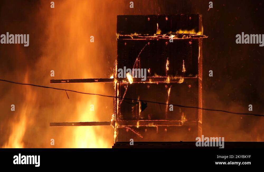 Burning debris falling off of piece of structure under construction in ...