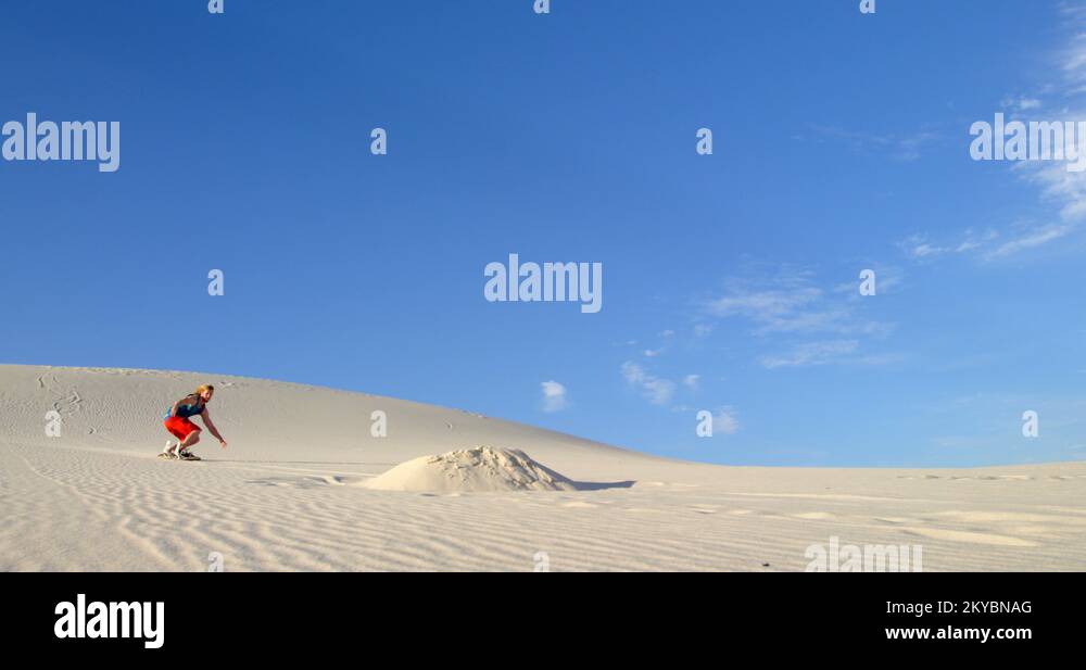 Man performing a jump while sand boarding 4k Stock Video Footage - Alamy