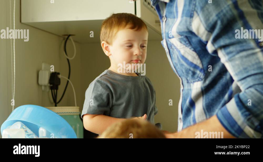 Father and siblings cleaning kitchen sink 4k Stock Video Footage - Alamy