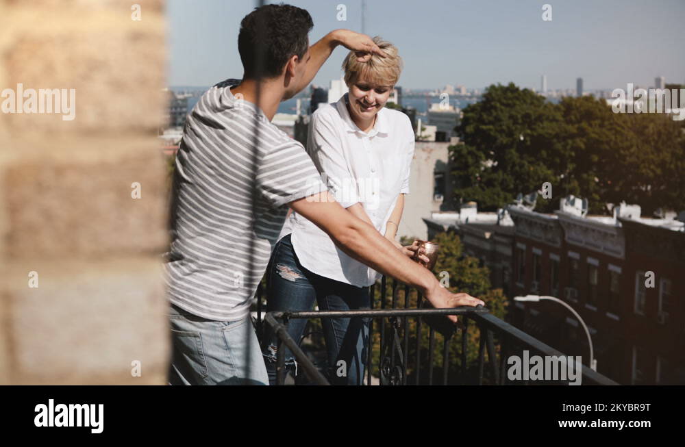 Beautiful young romantic couple standing together, enjoying talking at ...