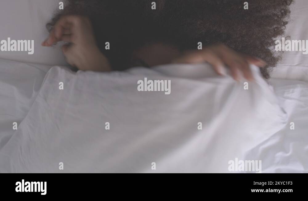 Black girl waking up at home after sleeping in bedroom bed Stock Video ...