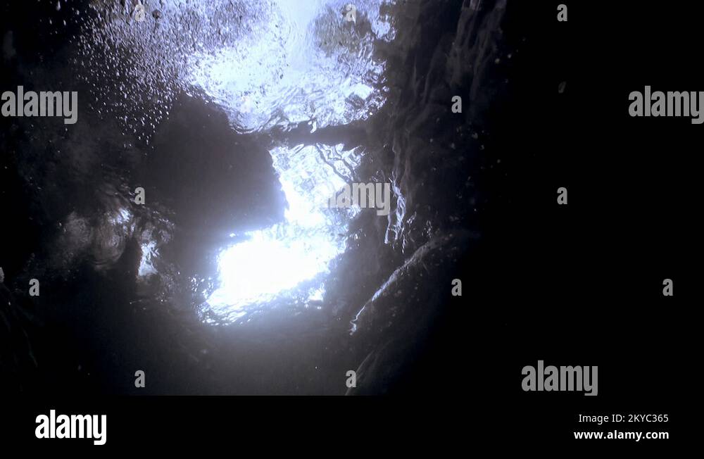 Refraction of sunlight underwater on smooth stones of river Verzasca ...