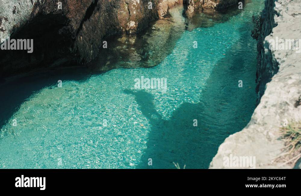Shadow On The Bottom Of A Crystal Clear River, Of A Man Jumping From A ...