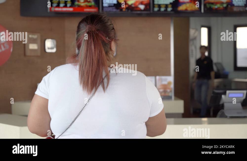 Overweight woman ordering fast foods in cafe Stock Video Footage - Alamy
