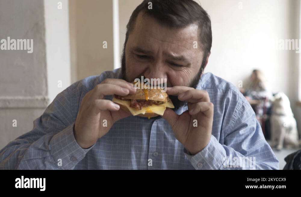 Man eating burger Stock Videos & Footage - HD and 4K Video Clips - Alamy